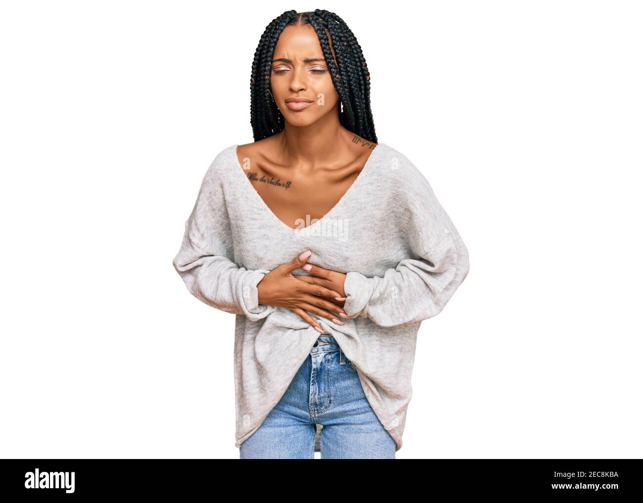 Beautiful hispanic woman wearing casual clothes with hand on stomach ...
