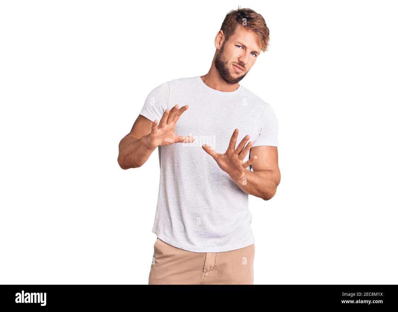Young caucasian man wearing casual white tshirt disgusted expression ...