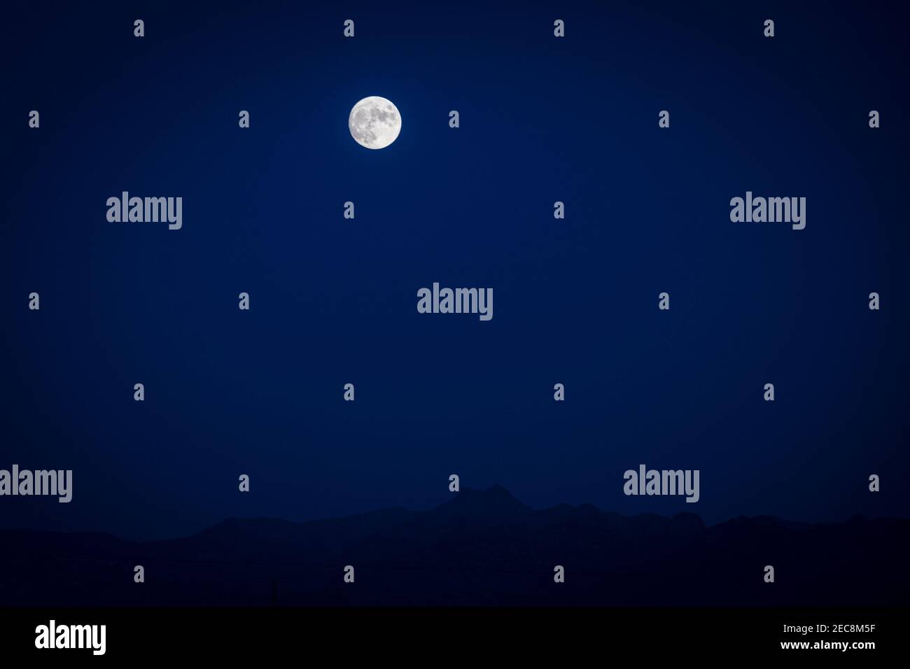 Moon over mountain range Stock Photo - Alamy