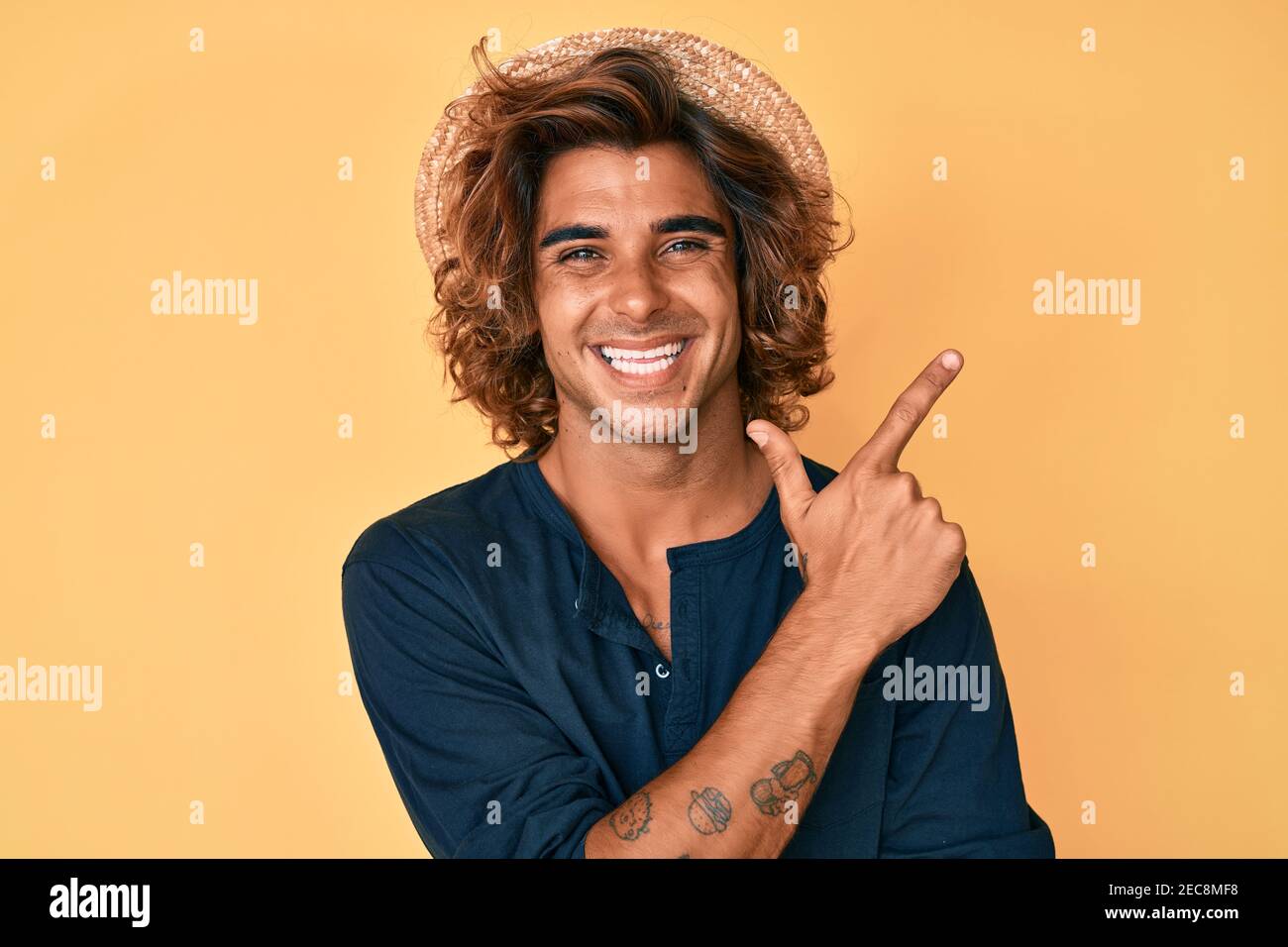Young hispanic man wearing summer hat with a big smile on face ...
