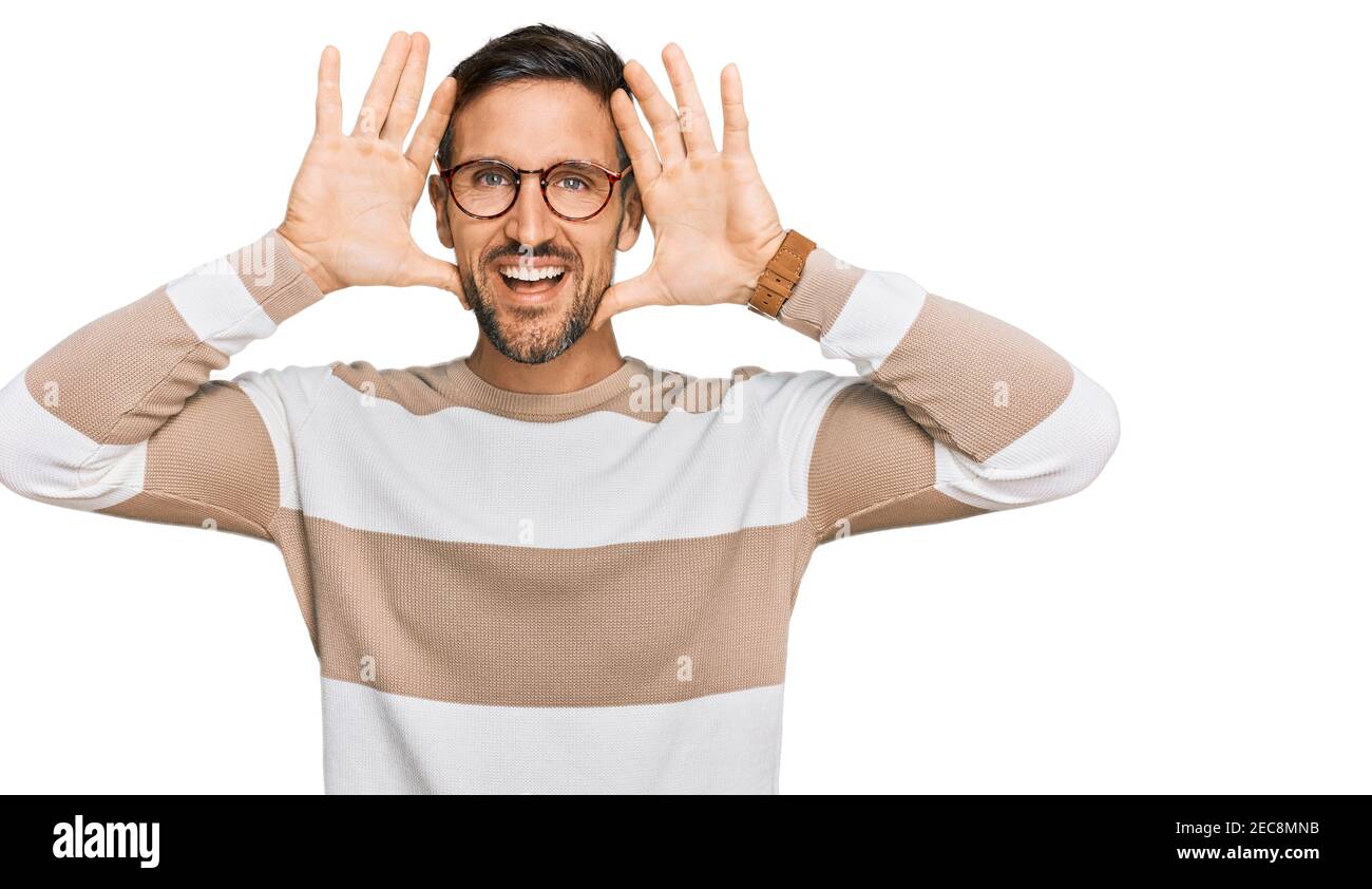 Handsome man with beard wearing casual clothes and glasses smiling ...