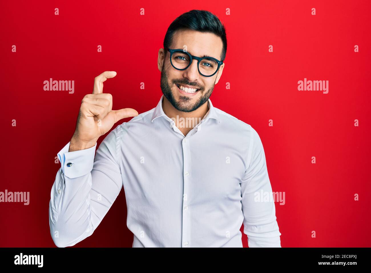 Young hispanic businessman wearing shirt and glasses smiling and ...