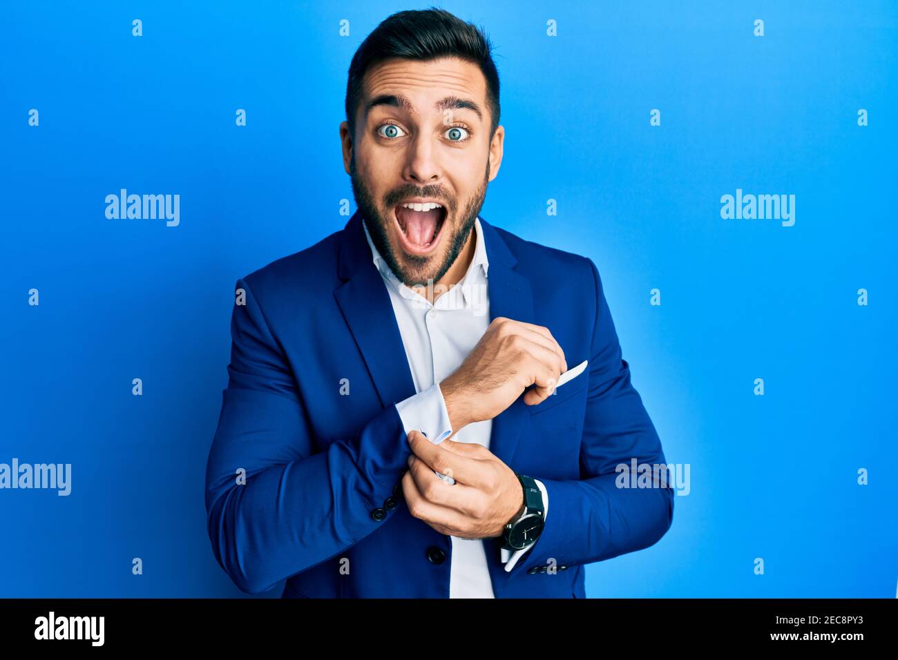 Young hispanic businessman wearing business jacket putting on shirt ...