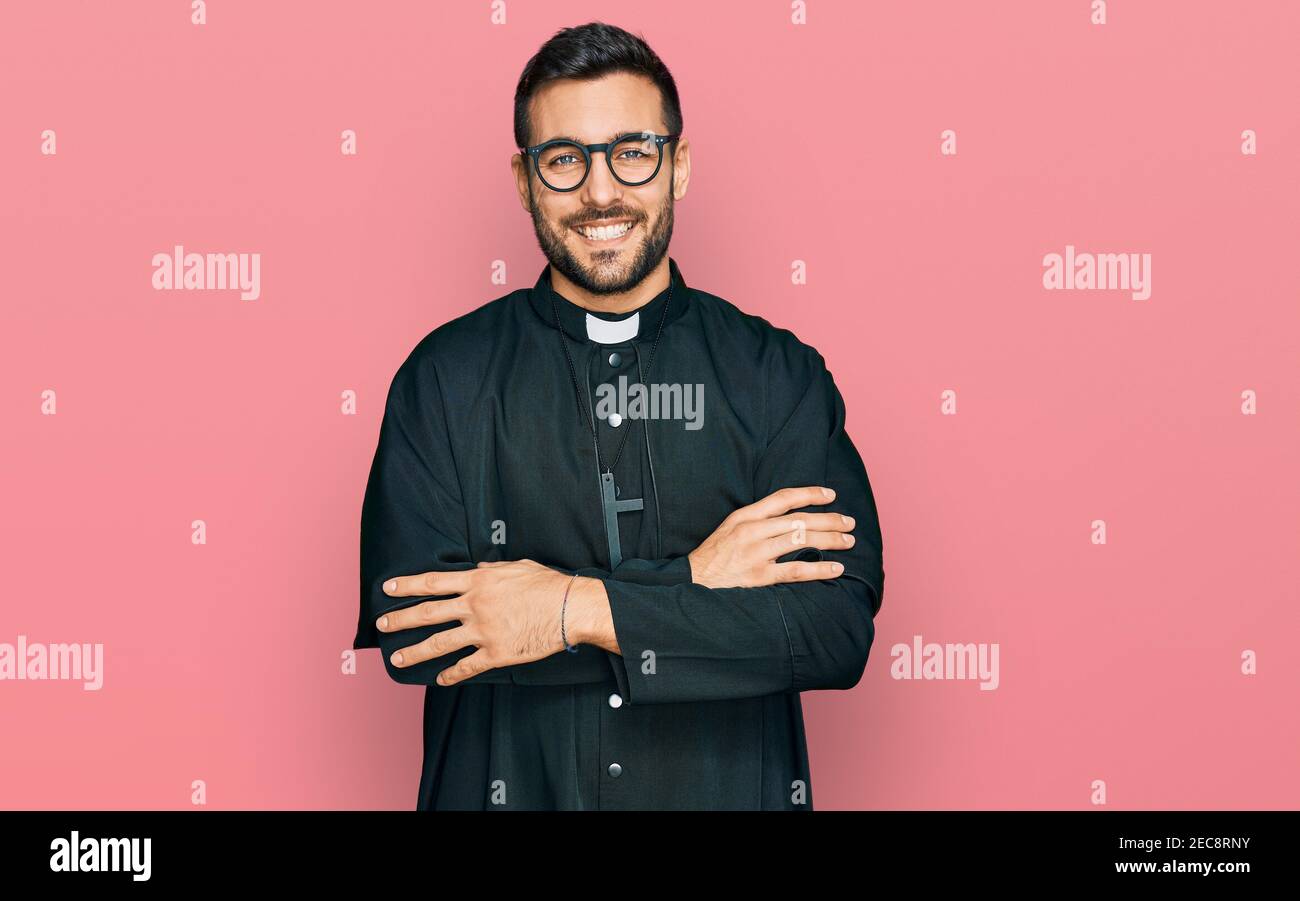 Young hispanic man wearing priest uniform happy face smiling with ...