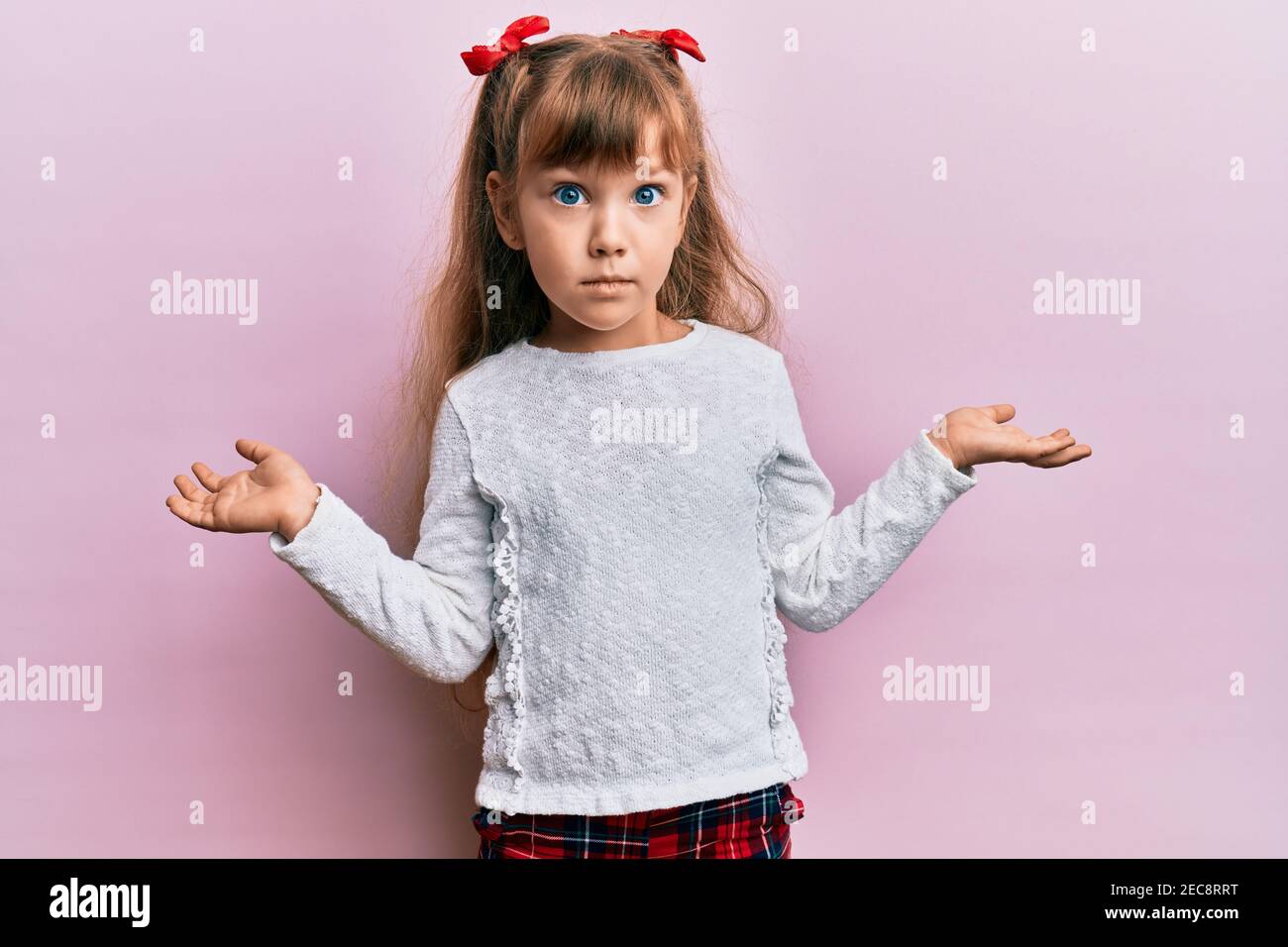 Little caucasian girl kid wearing casual clothes clueless and confused ...