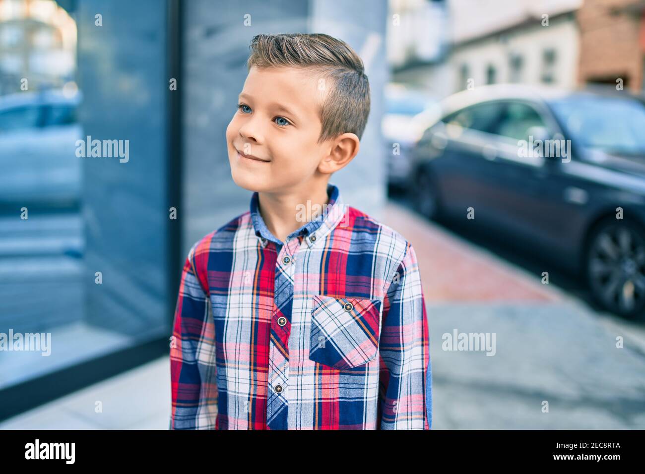 Adorable caucasian boy smiling happy standing at the city Stock Photo - Alamy