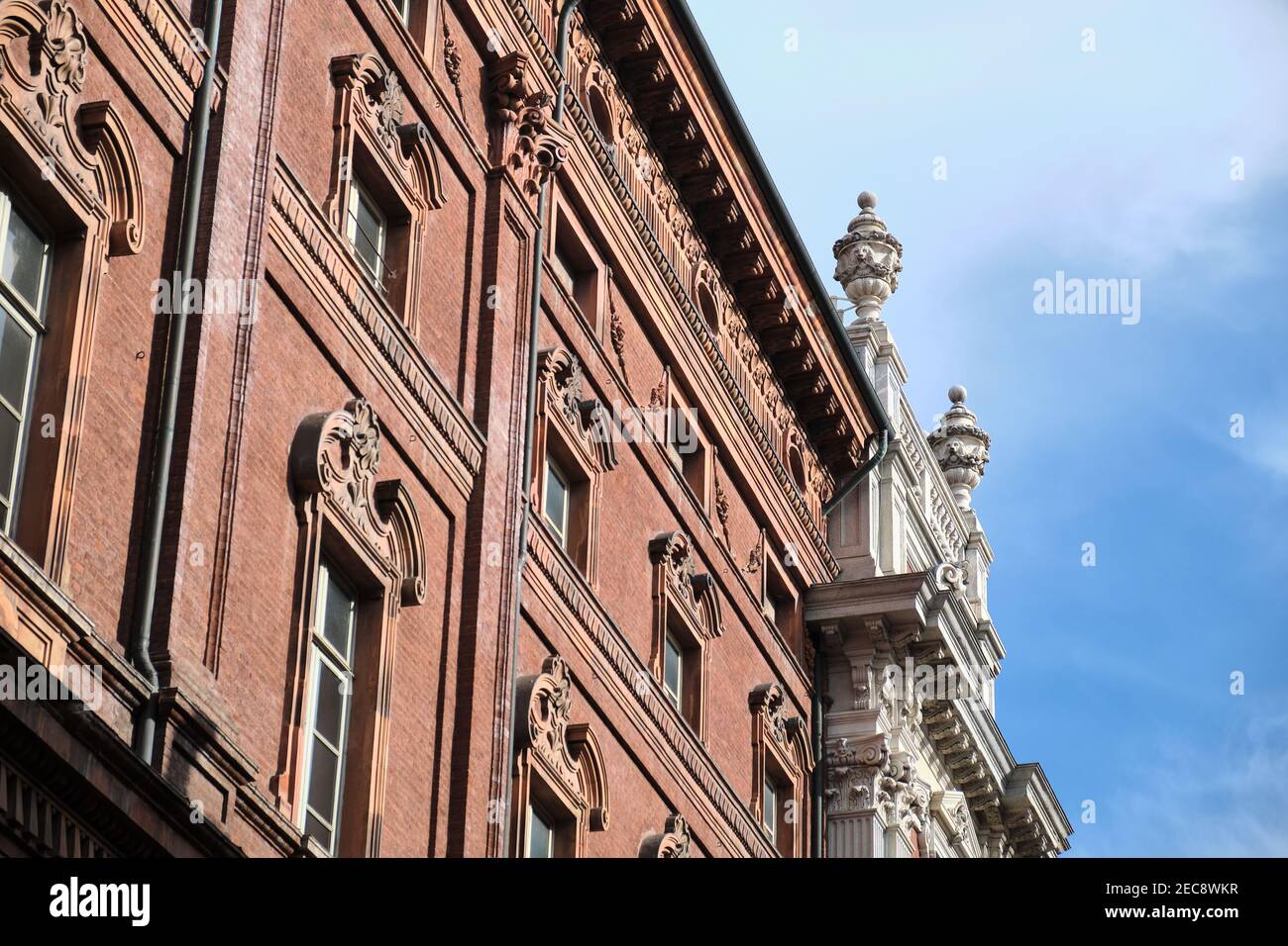 marble capitals on the Art Nouveau facade of a red brick palace Stock ...