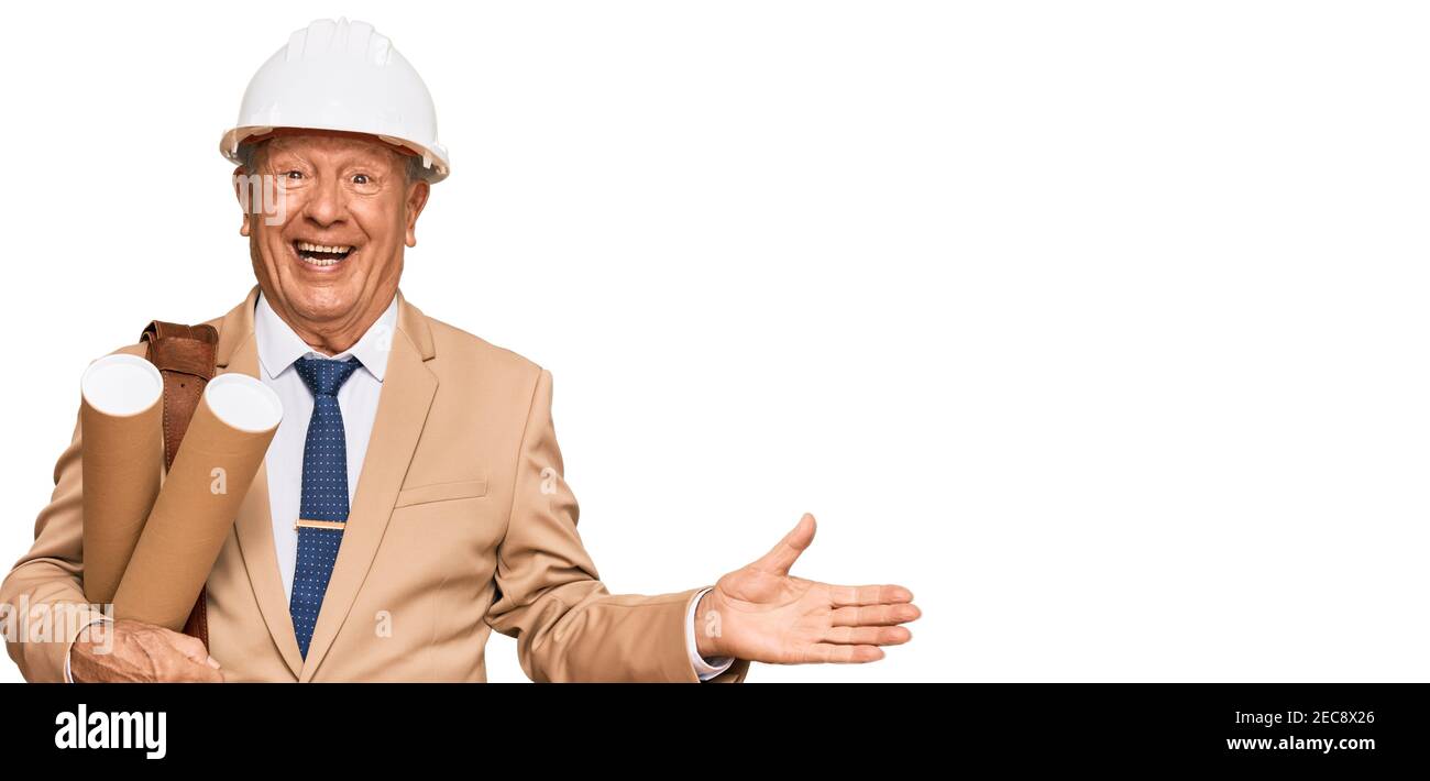 Senior caucasian man wearing safety helmet holding blueprints ...