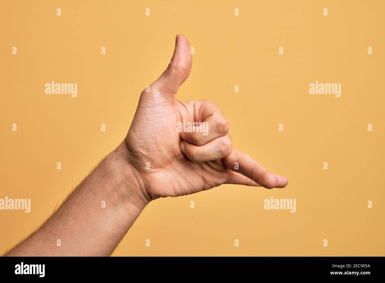 Hand of caucasian young man showing fingers over isolated yellow ...