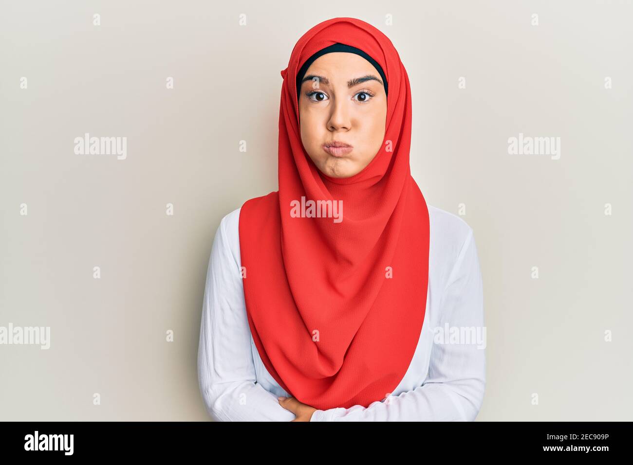 Young beautiful hispanic girl wearing traditional islamic hijab scarf ...
