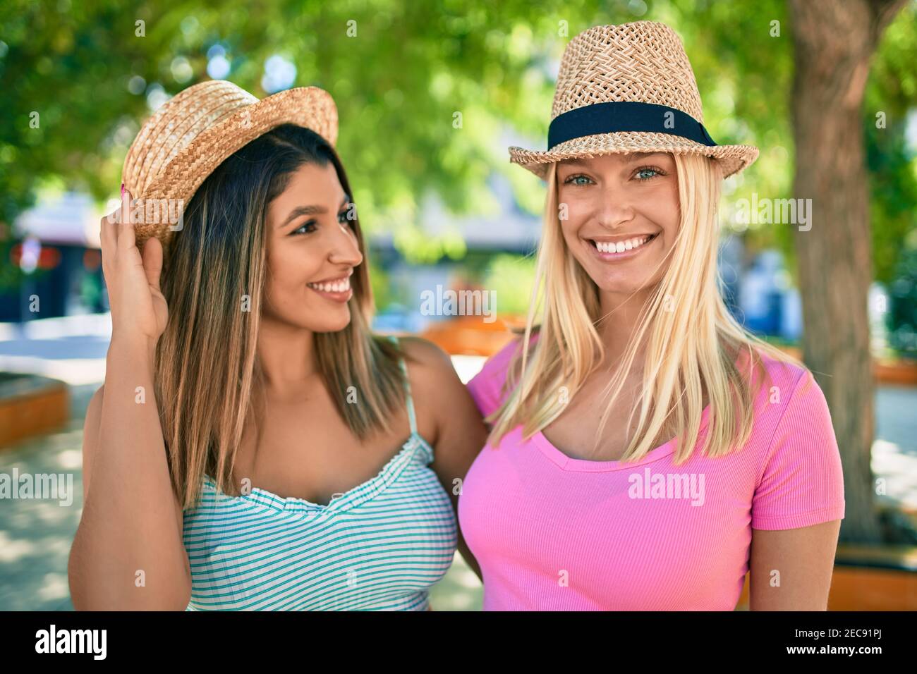 Two beautiful and young girl friends together having fun at the city ...