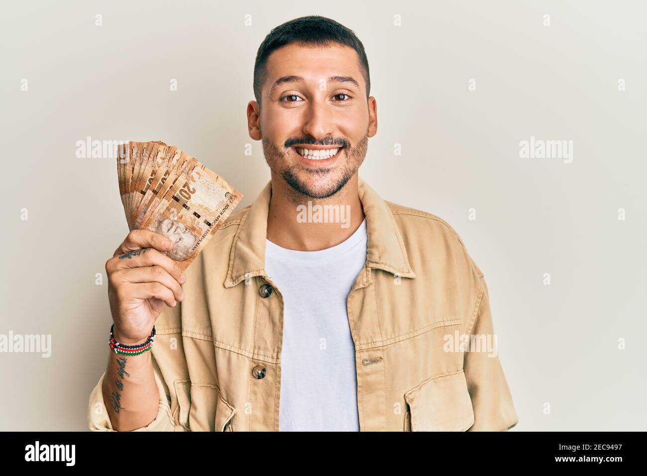 Handsome man with tattoos holding south african 20 rand banknotes ...