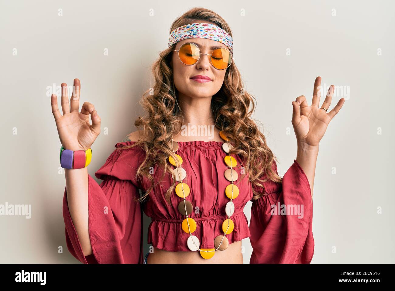 Young blonde girl wearing bohemian and hippie style relax and smiling ...