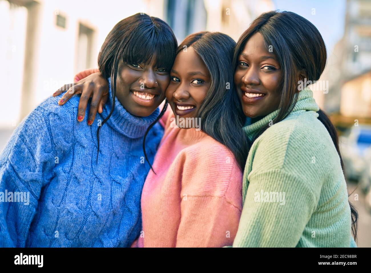 Three african american friends smiling happy hugging at the city Stock ...