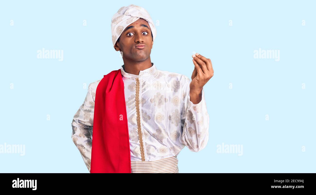 African handsome man wearing tradition sherwani saree clothes doing ...