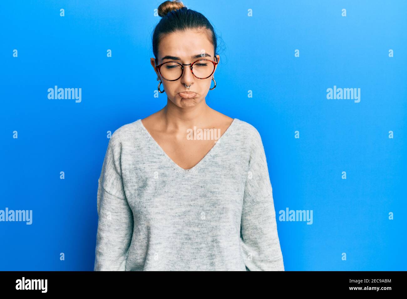 Young hispanic woman wearing casual clothes depressed and worry for ...