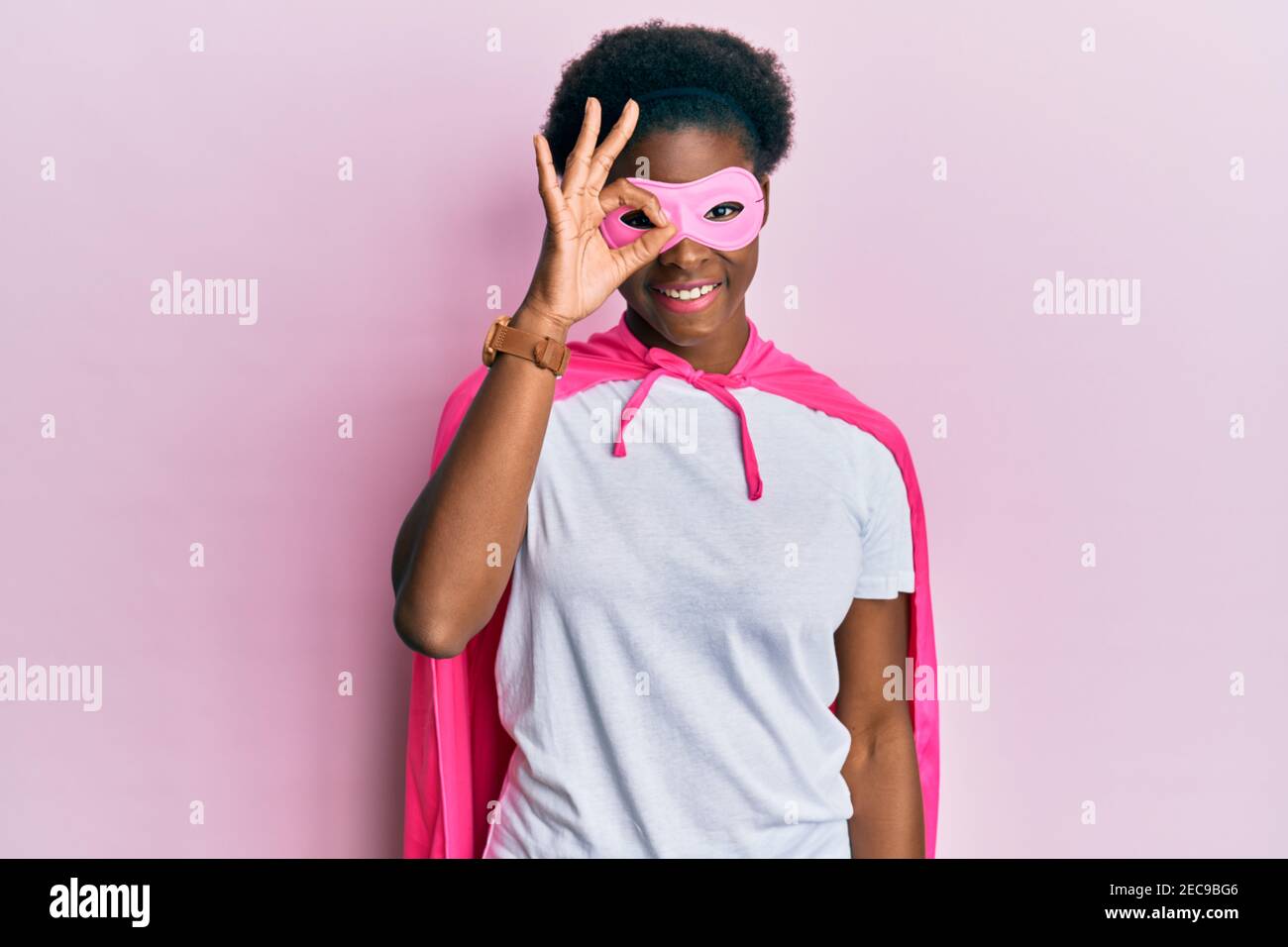 Young african american girl wearing superhero mask and cape costume ...