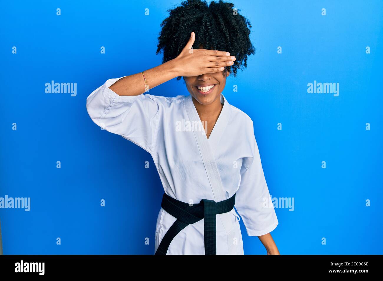African american woman with afro hair wearing karate kimono and black ...
