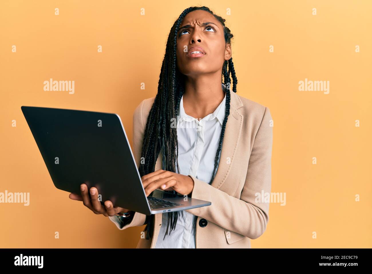 African american woman working using computer laptop angry and mad ...