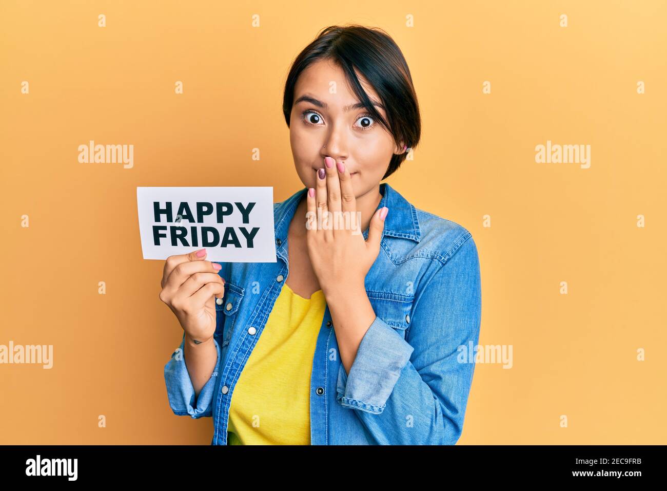 Beautiful young woman with short hair holding happy friday message ...