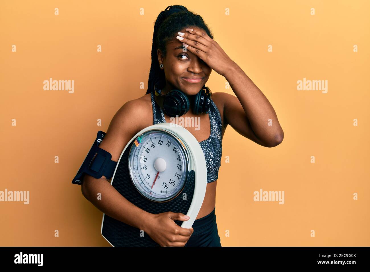 African american woman with braided hair wearing sportswear holding ...