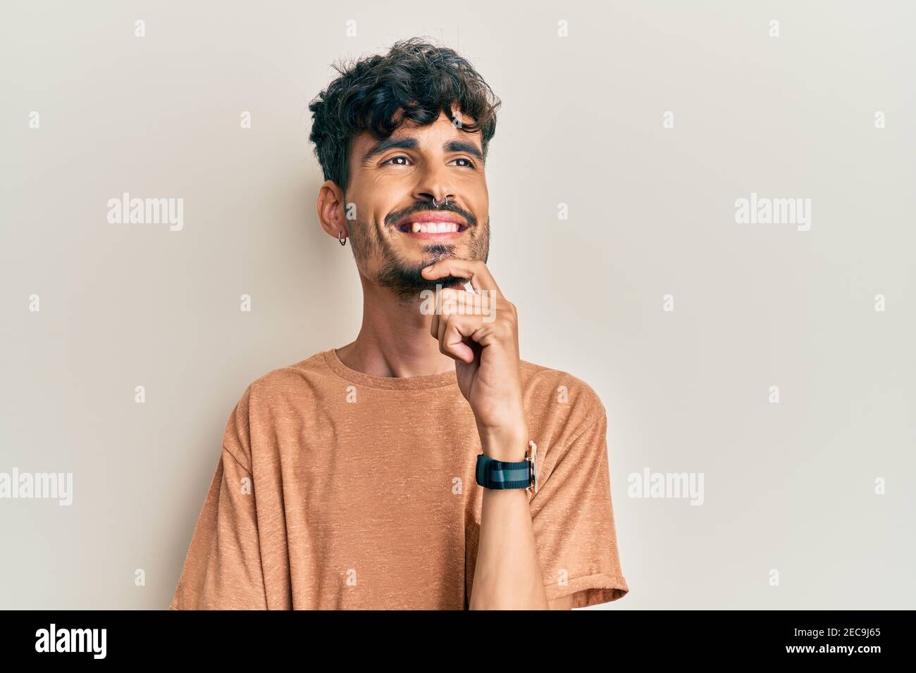 Young hispanic man wearing casual clothes looking confident at the ...