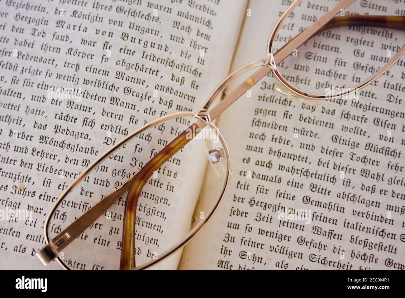 Reading glasses on an old book edition of Schiller`s works Stock Photo ...