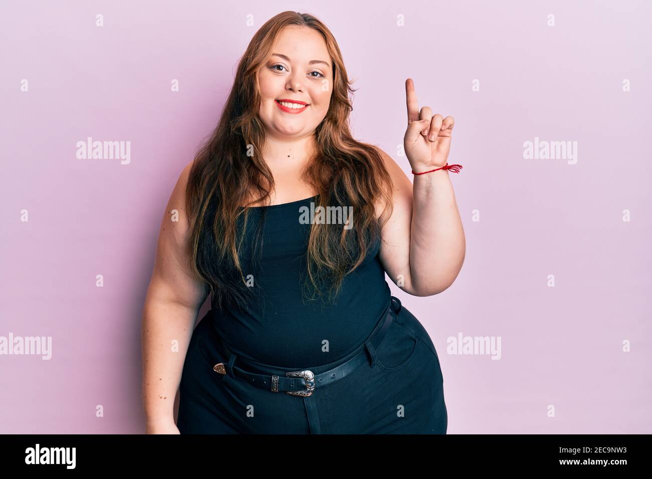 Plus size caucasian young woman wearing casual clothes over pink ...