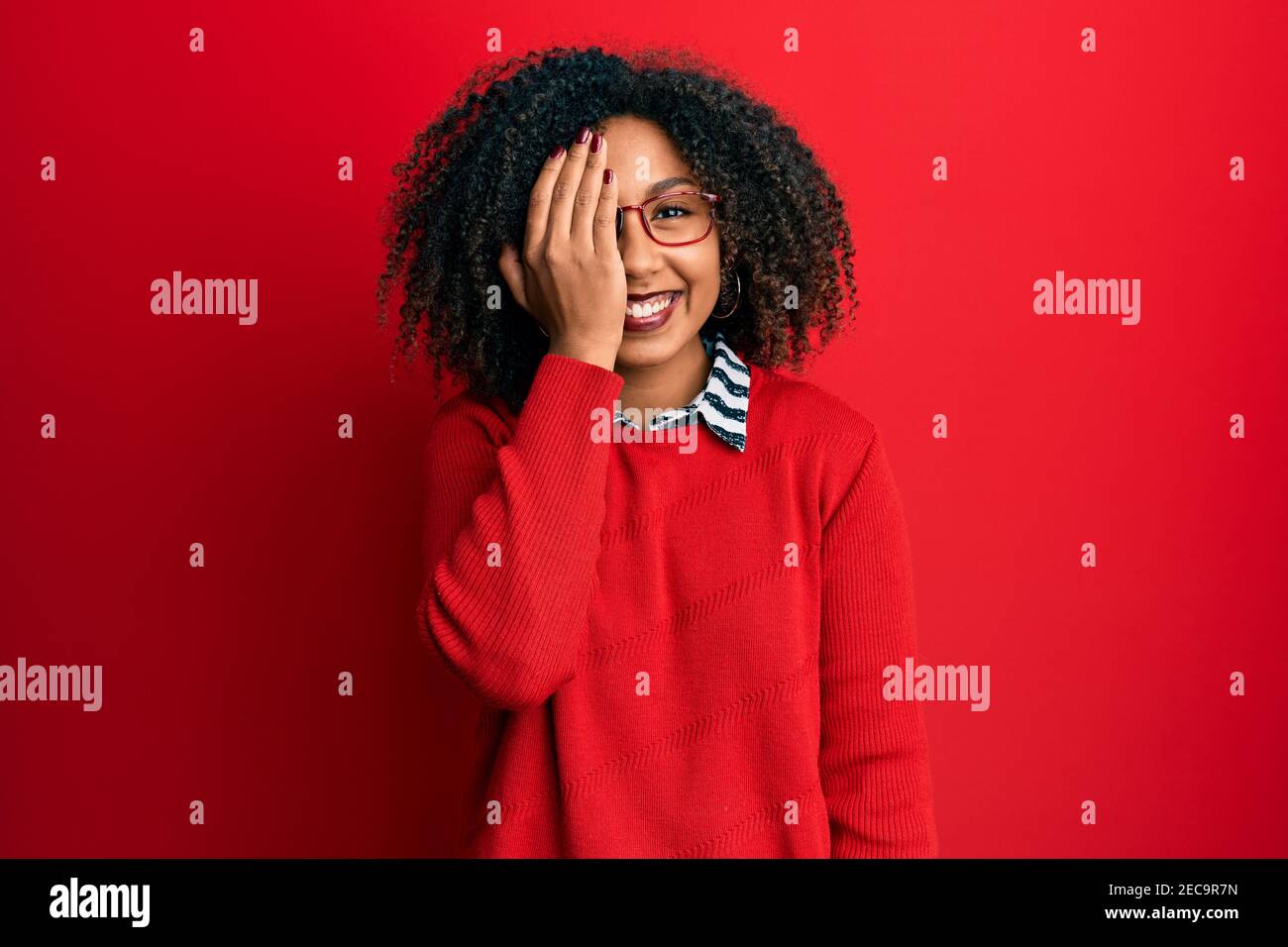 Beautiful african american woman with afro hair wearing sweater and ...