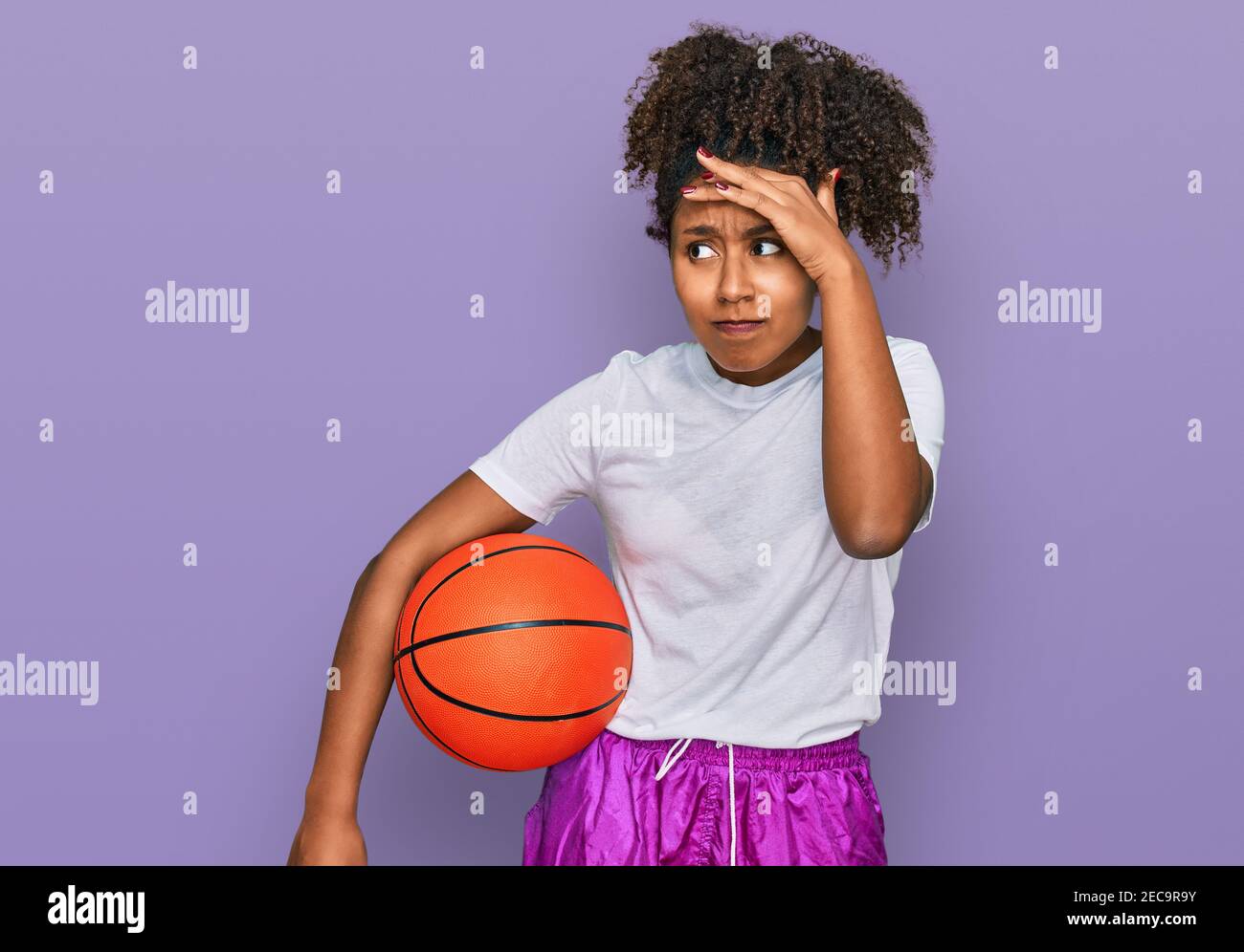 Young african american girl playing baseball holding bat and ball ...
