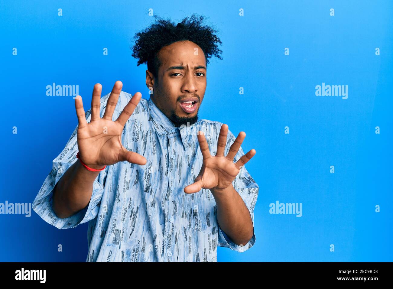 Young african american man with beard wearing casual clothes afraid and ...