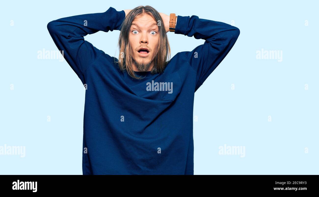 Handsome caucasian man with long hair wearing casual winter sweater ...