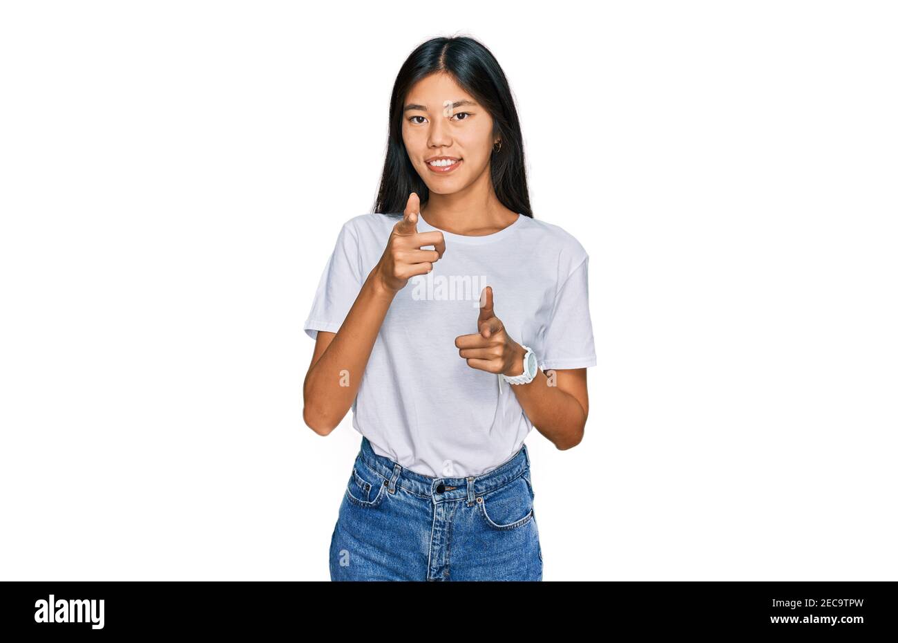 Beautiful young asian woman wearing casual white t shirt pointing ...