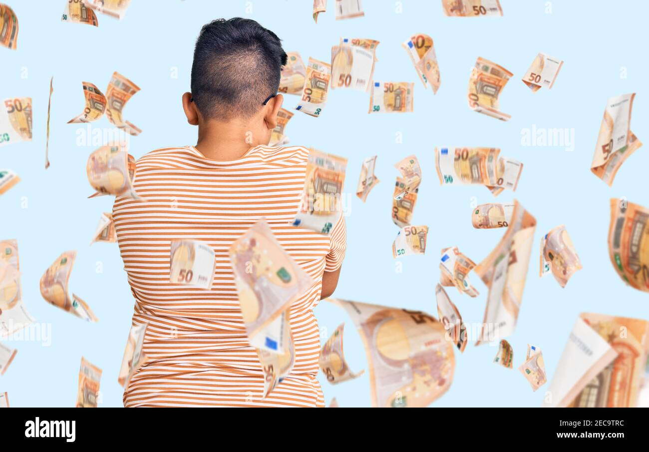 Little boy kid wearing casual clothes and glasses standing backwards ...