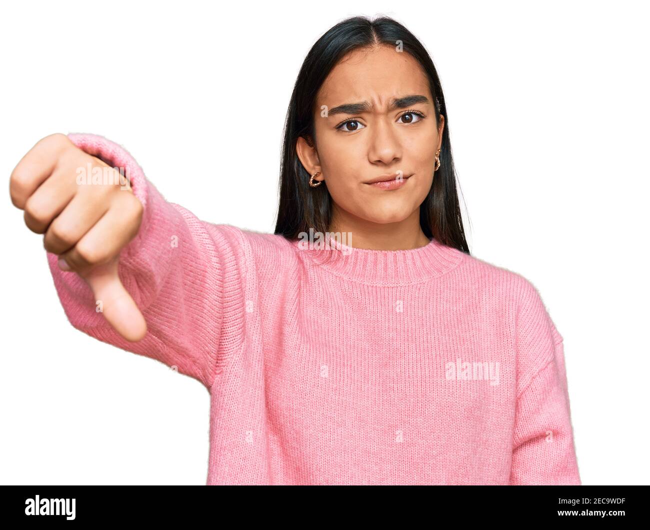 Young asian woman wearing casual winter sweater looking unhappy and ...