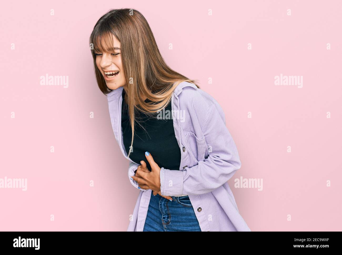 Teenager caucasian girl wearing casual clothes with hand on stomach ...