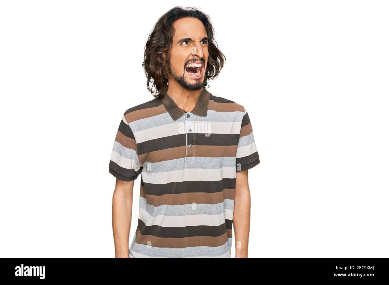 Young hispanic man wearing casual clothes angry and mad screaming ...