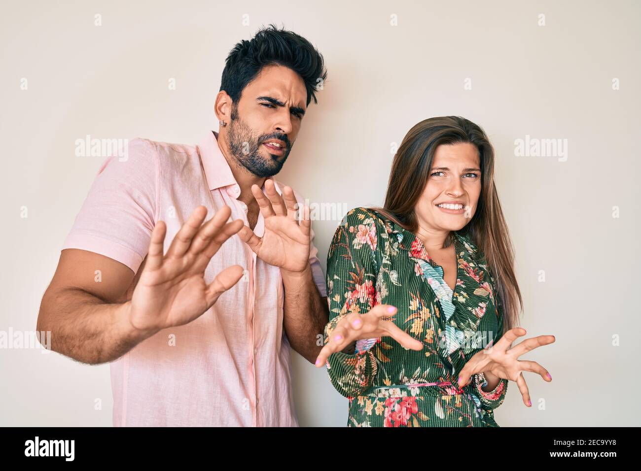 Beautiful young couple of boyfriend and girlfriend together disgusted ...