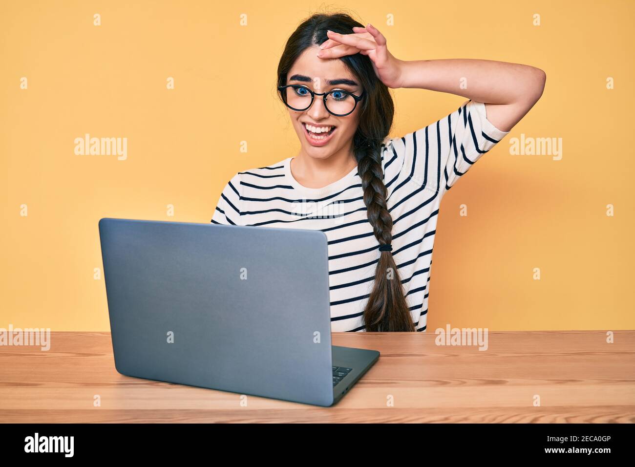 Brunette teenager girl working using computer laptop stressed and ...
