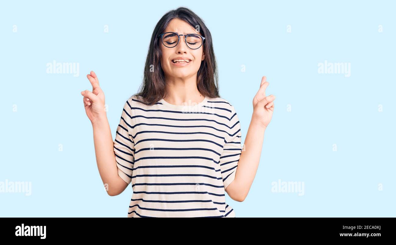 Brunette teenager girl wearing casual clothes and glasses gesturing ...