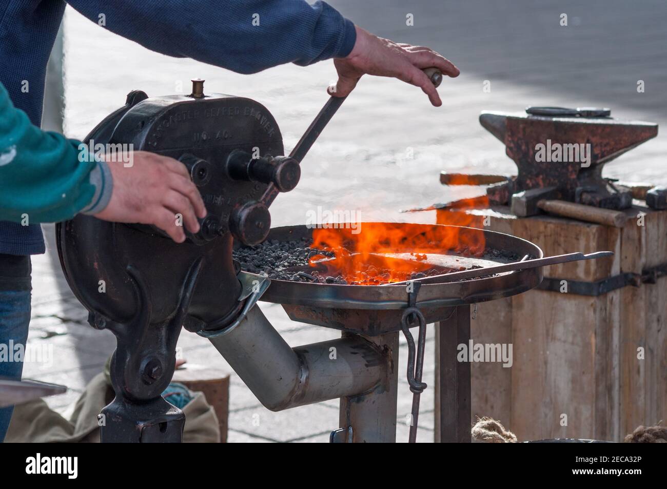 metalsmith blowing air on the fire Stock Photo - Alamy