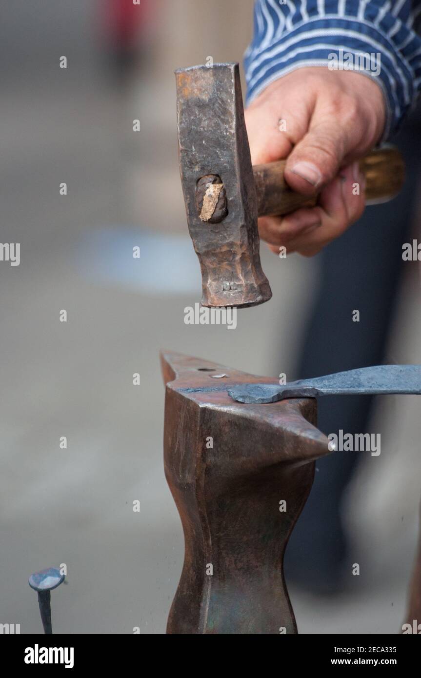 metalsmith hammering the iron Stock Photo - Alamy