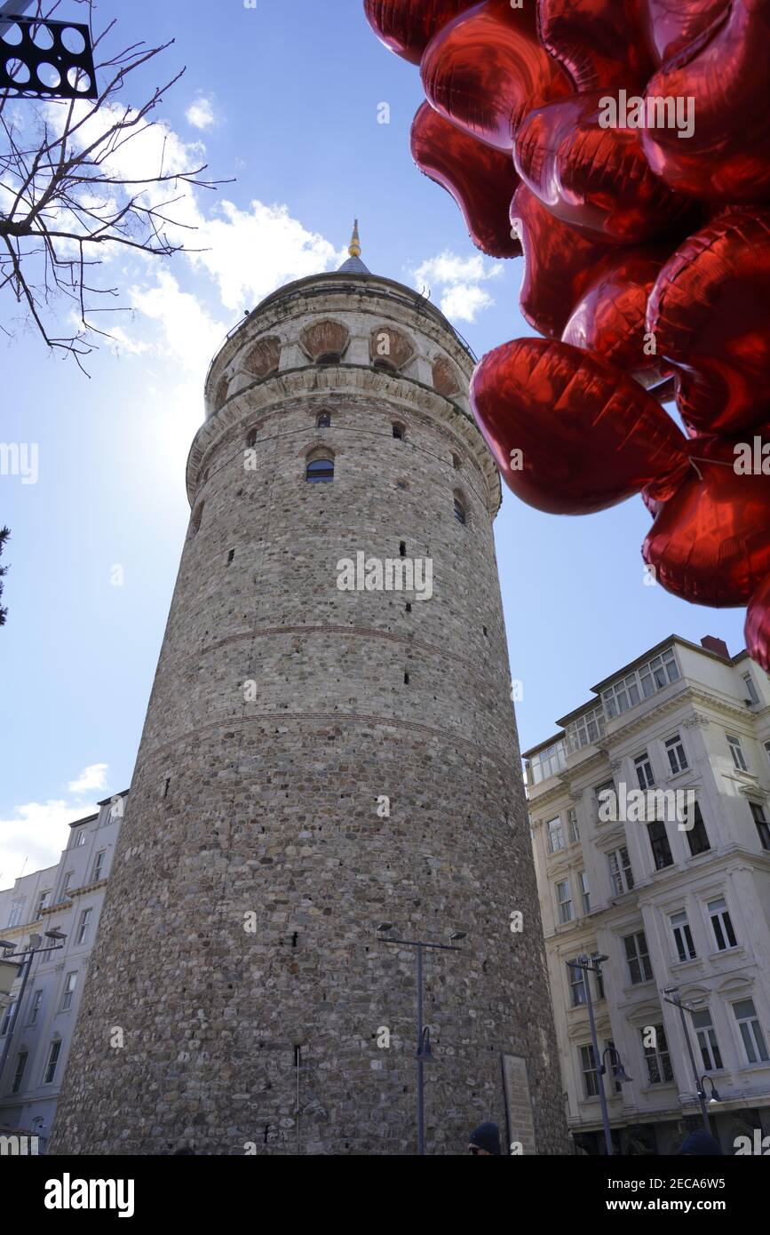 Vertical shot of heart-shaped balloons in front of the Galata tower ...