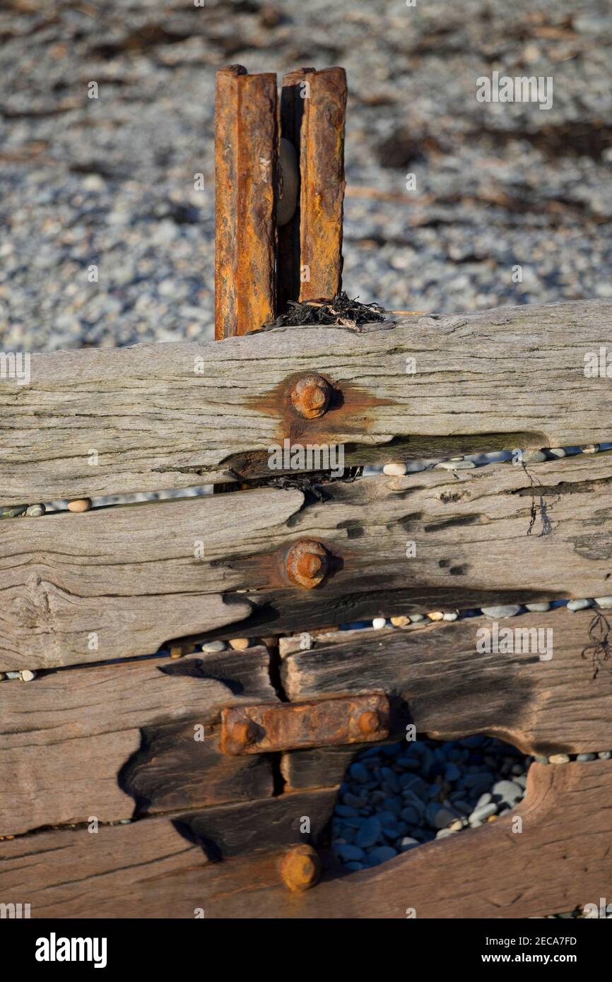 Beach with stacked limestone, pebbles and rusty metal frame in ...