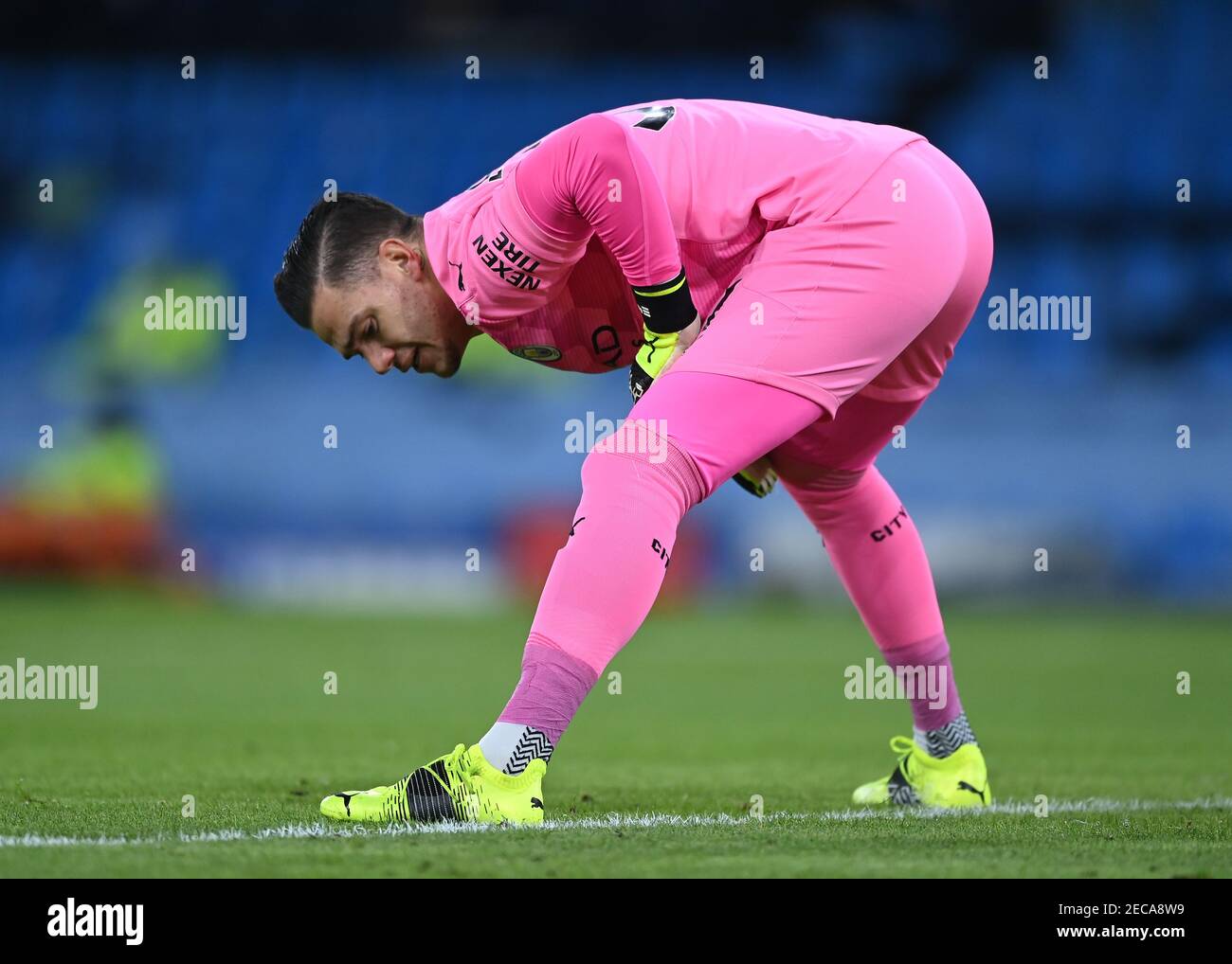 Manchester City goalkeeper Ederson stretches prior to kick-off during ...