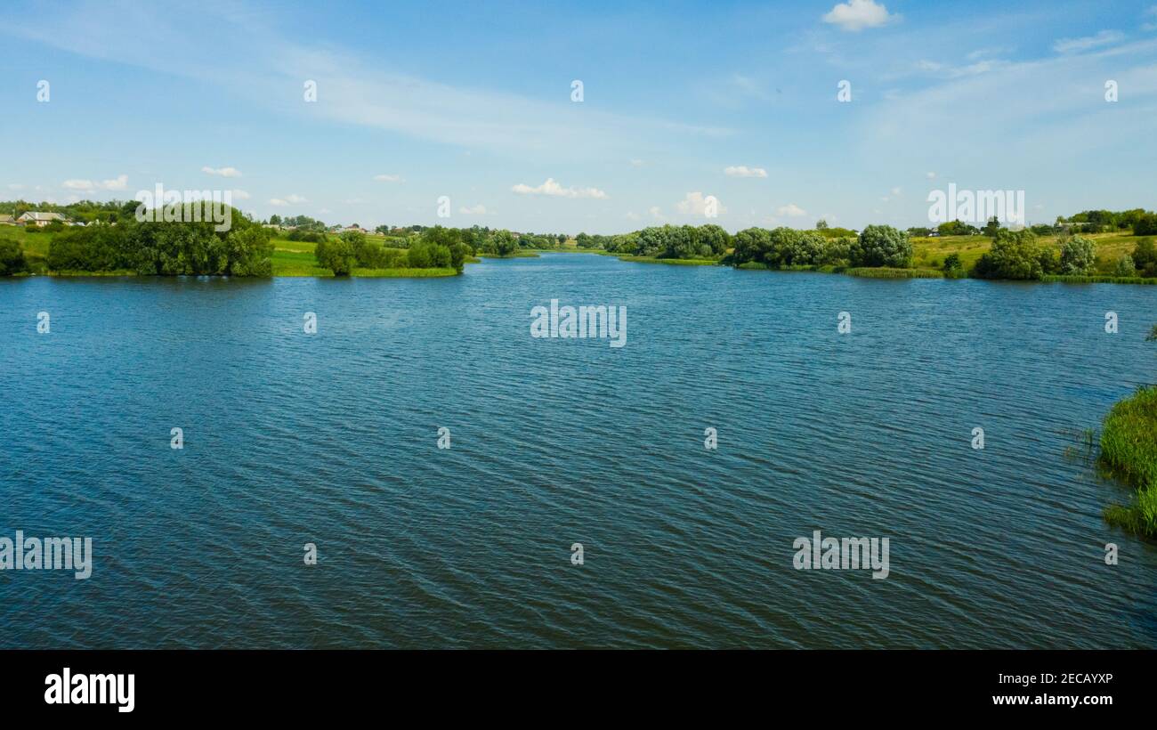Scenic aerial view of river and green fields in Russian countryside ...