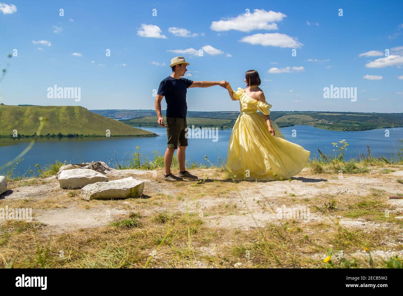 A young couple dancing on a cliff by the bay Stock Photo - Alamy