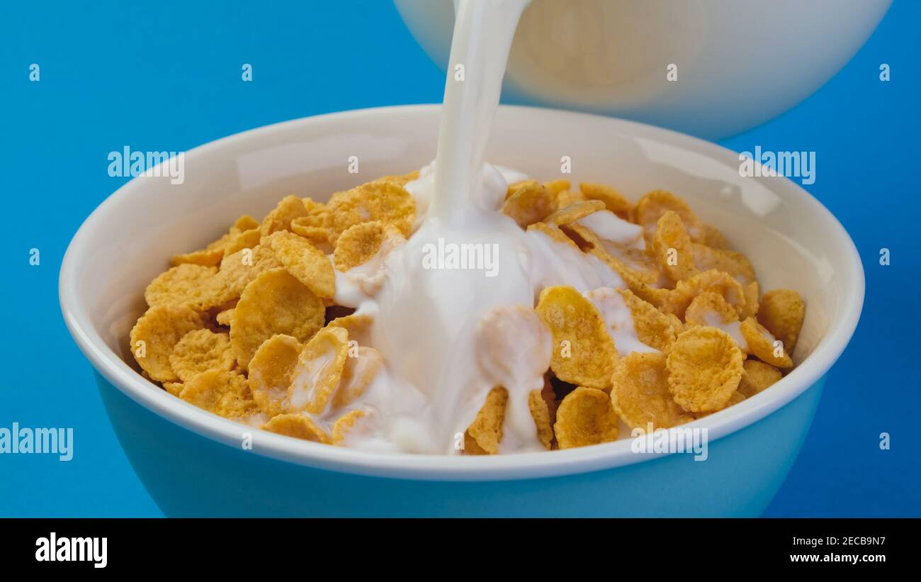 Milk pouring into bowl of corn flakes Stock Photo - Alamy
