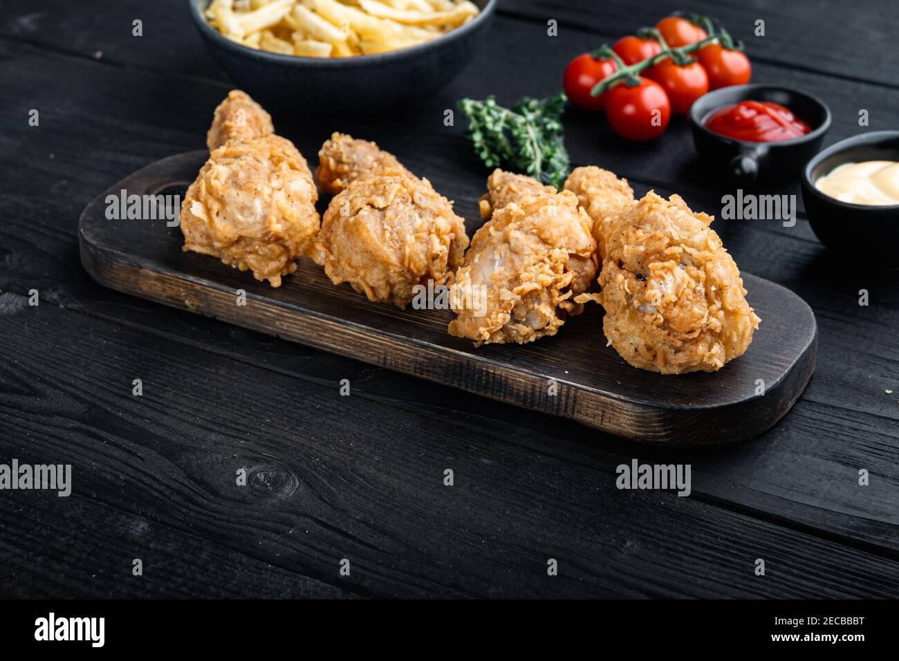Chicken leg breaded and fried on black wooden background Stock Photo ...
