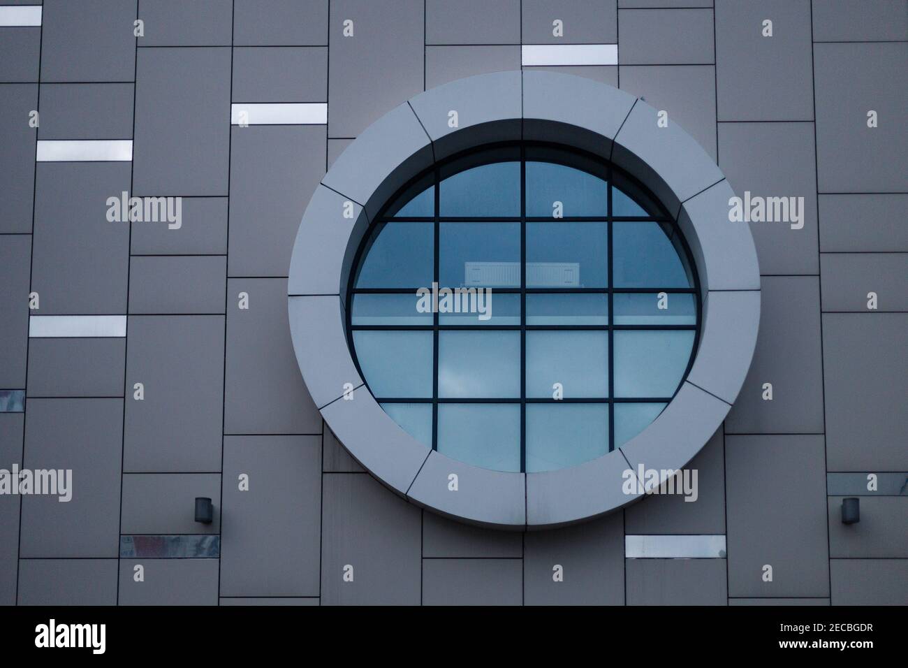 Big round window on a modern gray building Stock Photo - Alamy